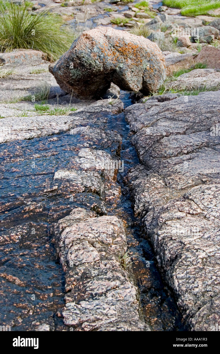 Crack in granite rock mountain with water running in it Stock Photo - Alamy
