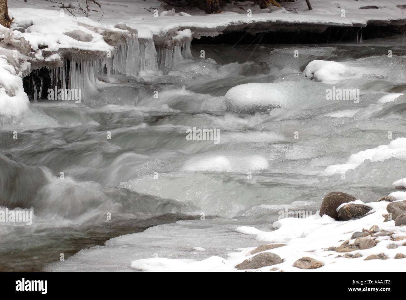 Waters flows in a brook in the spring, as ice begins to melt in New ...