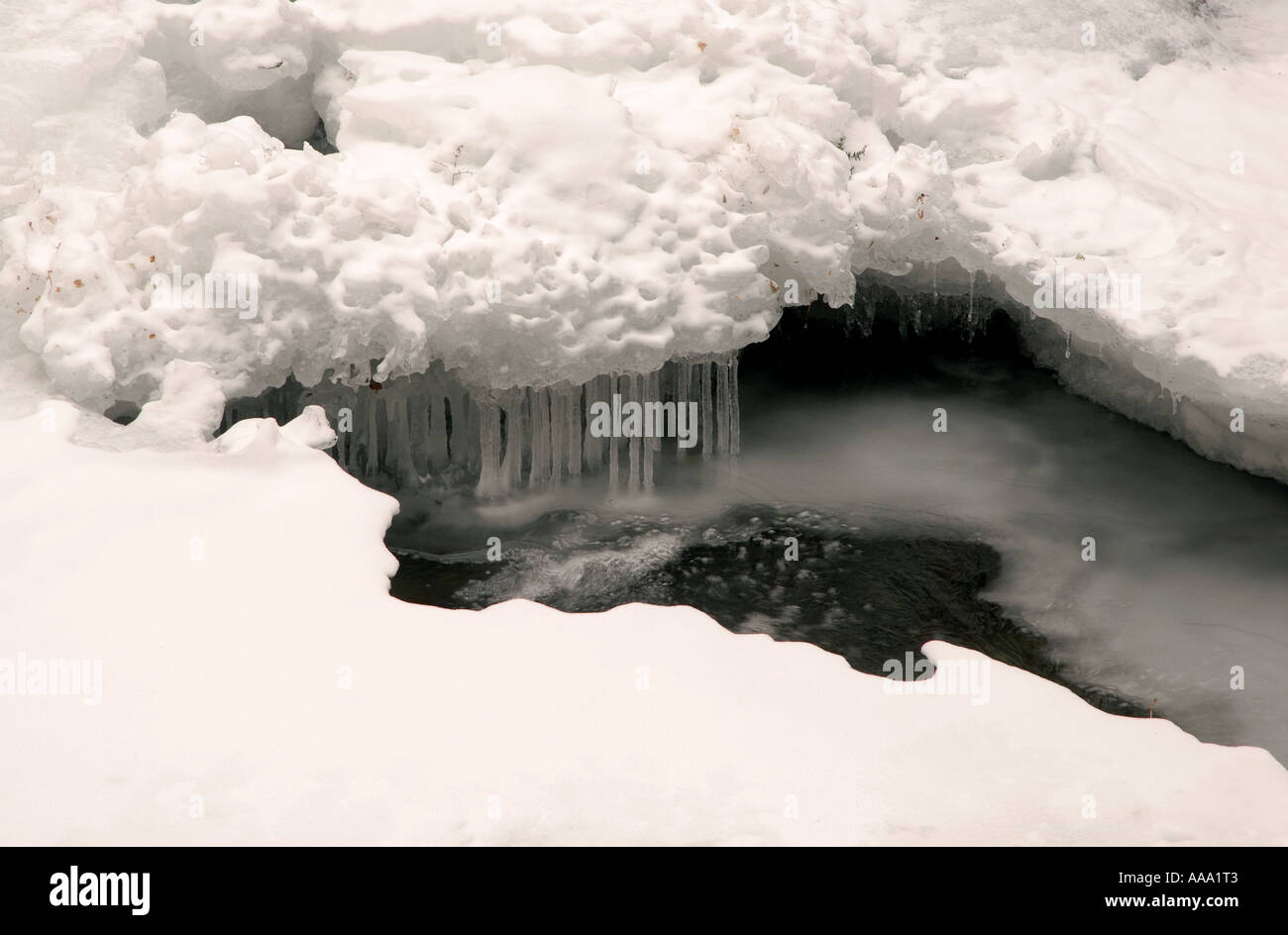 Waters flows in a brook in the spring, as ice begins to melt in New ...