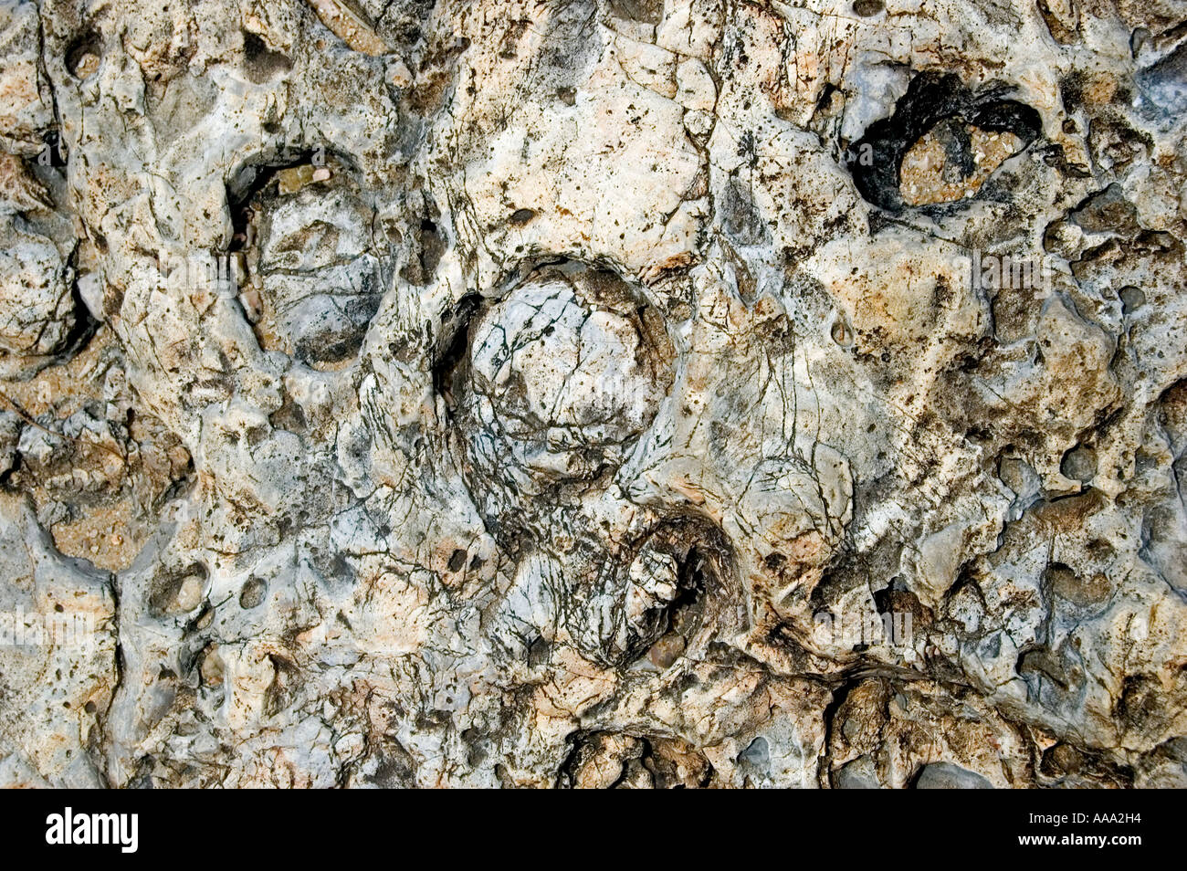 River rock patterns carved by water in lava or granite rock Stock Photo ...