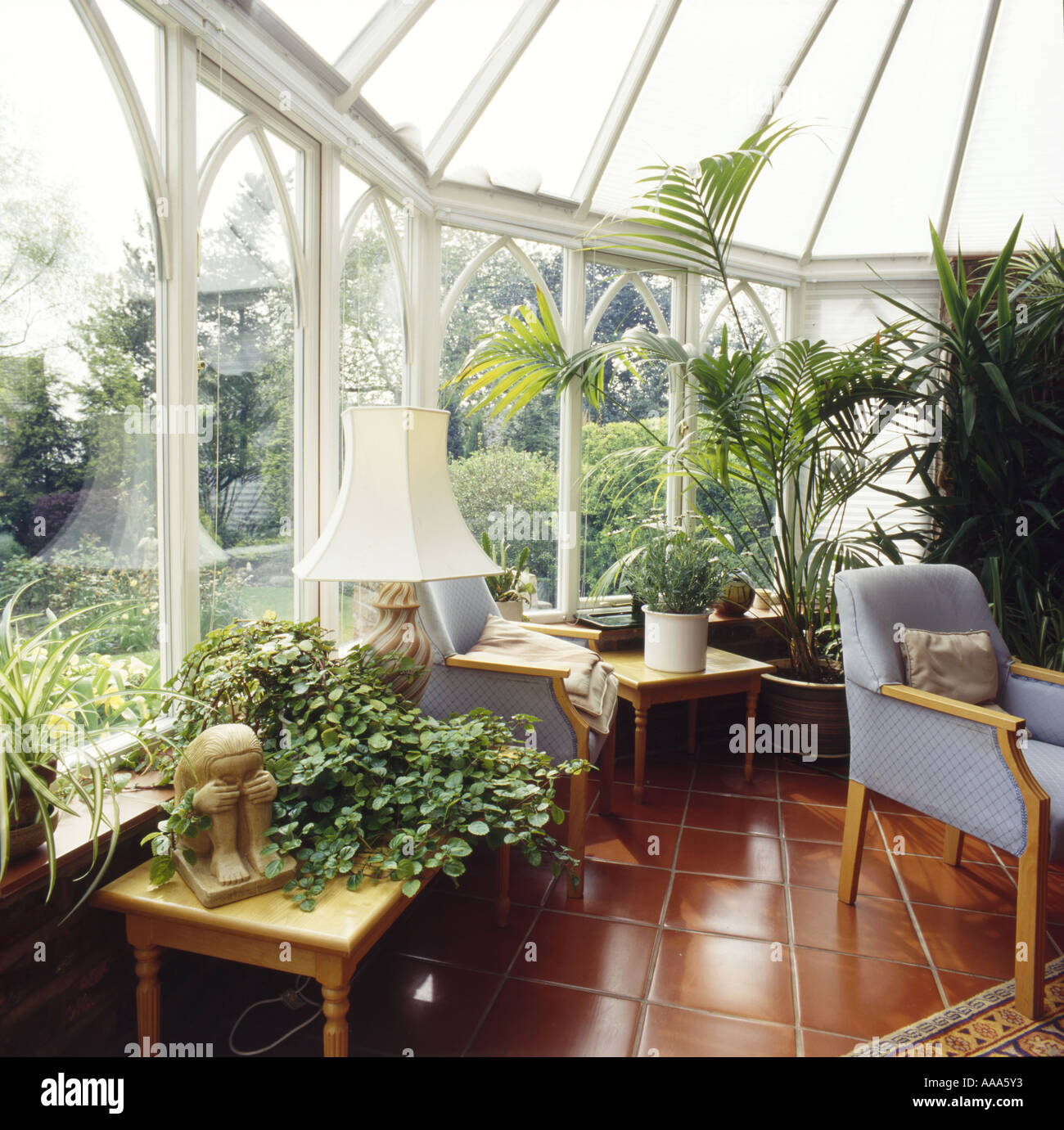 large conservatory with cane furniture and mature plants Stock Photo ...