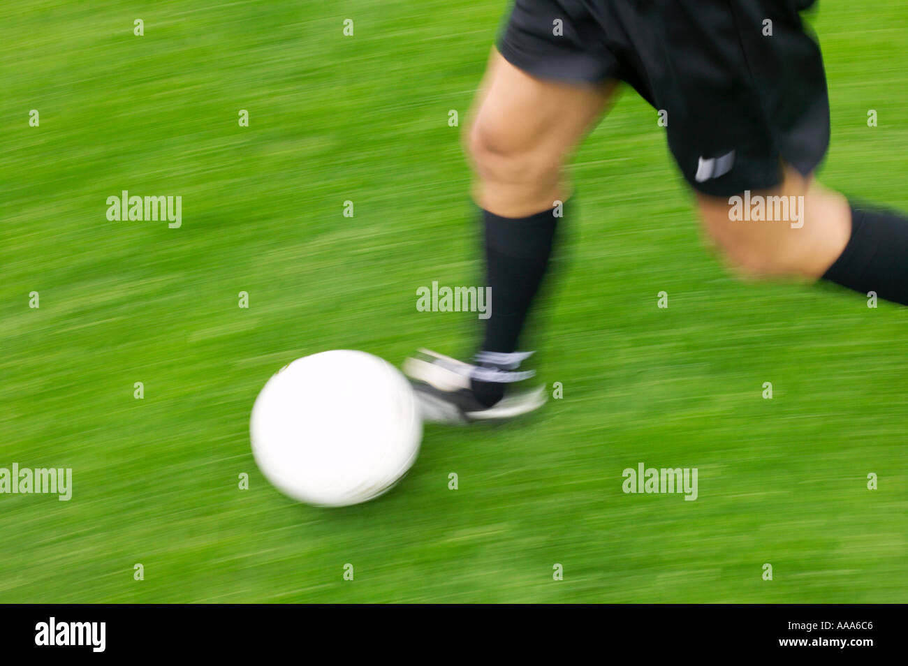 legs of soccer player running after ball Stock Photo - Alamy
