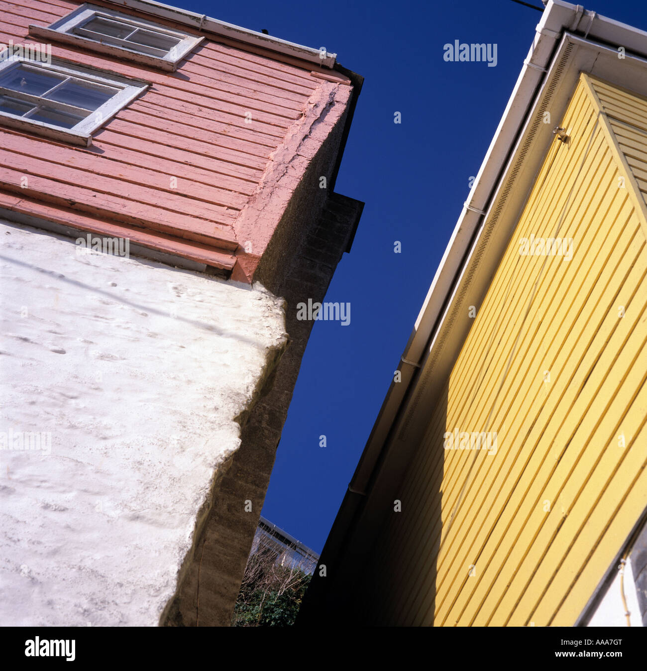 Colour and texture from an unusual angle looking up at houses built on ...