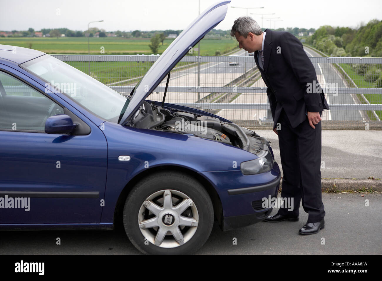 Car breakdown Businessman s car breakdown Checking under the hood Stock ...