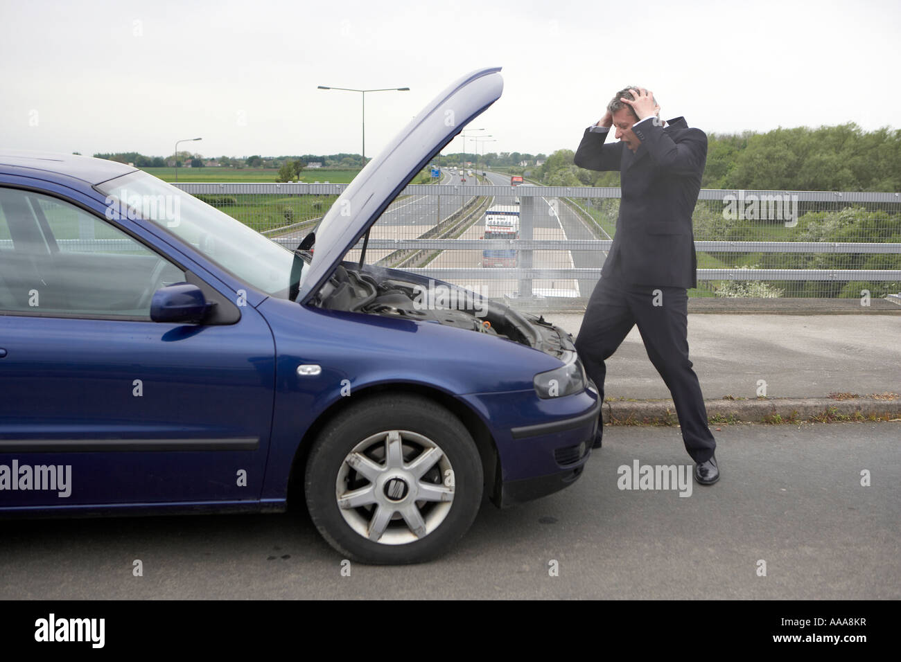 Car breakdown Businessman s car breakdown Checking under the hood Stock ...