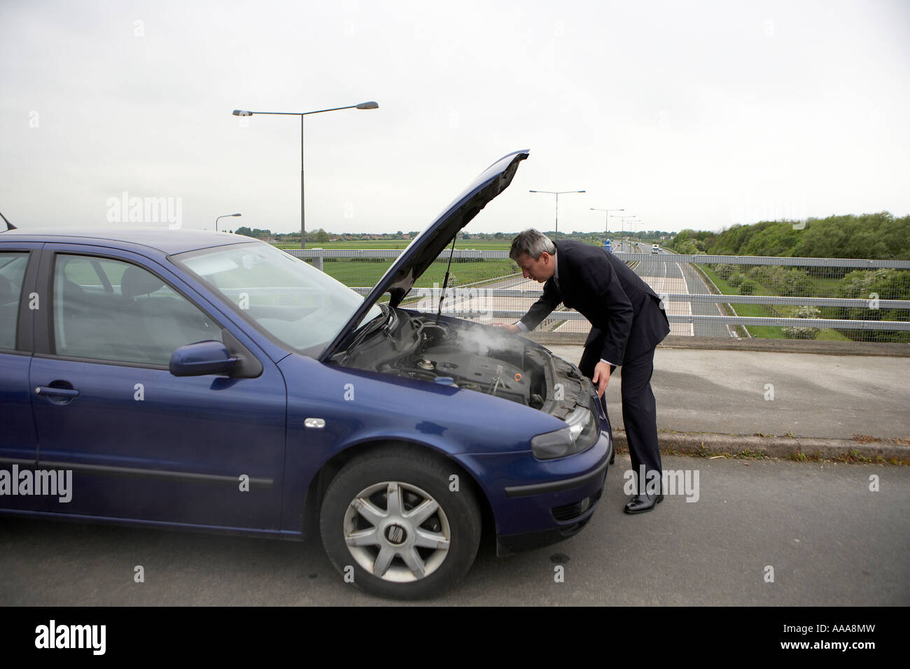 Car breakdown Businessman s car breakdown Checking under the hood Stock ...