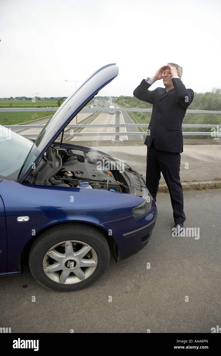 Car breakdown Businessman s car breakdown Checking under the hood. Head ...