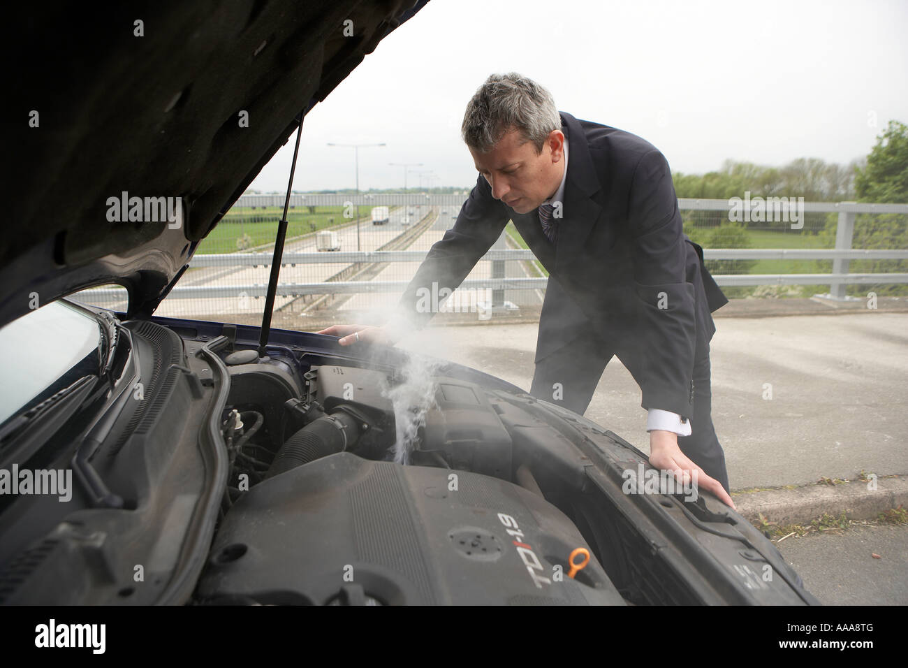 Car breakdown Businessman s car breakdown Checking under the hood Stock ...