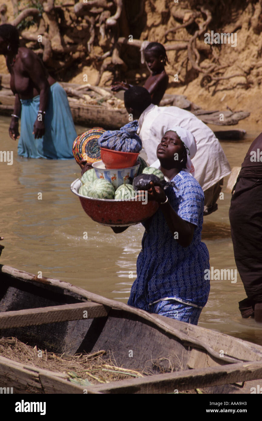Ayorou, Niger River, Niger, Africa. Lifting Basin of Melons onto Head ...