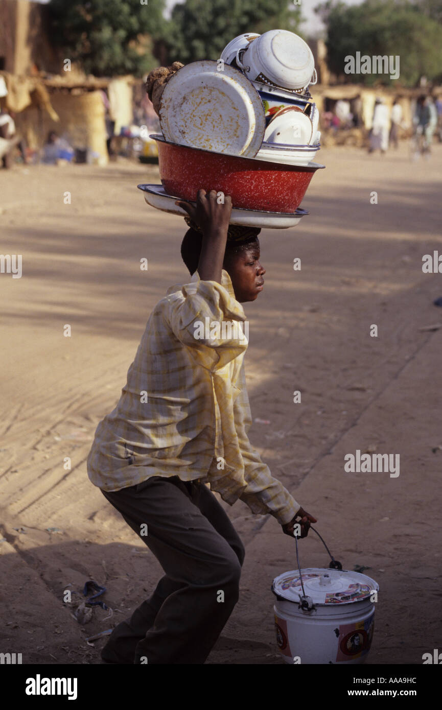 Zinder, Niger, West Africa. Man Carrying Pots and Pans on Head. Such ...
