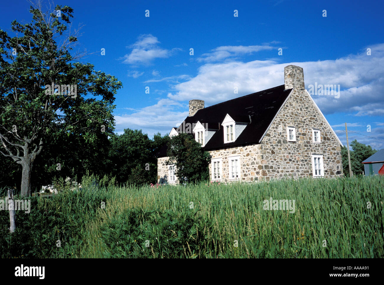 traditional quebec farmhouse on the shores of the st laurence river ...