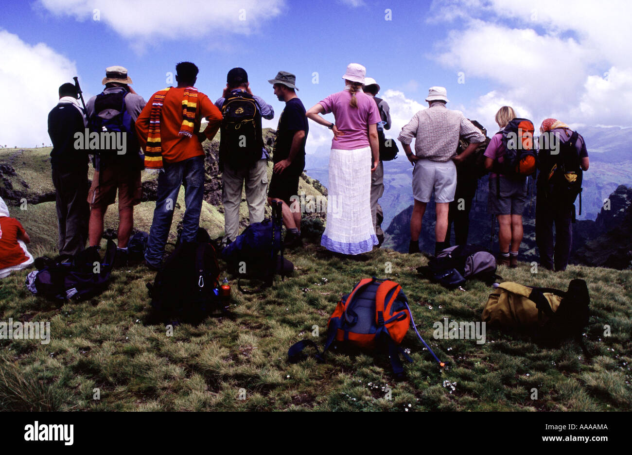 Group of trekkers looking over the edge of a mountain ridge, Simien ...
