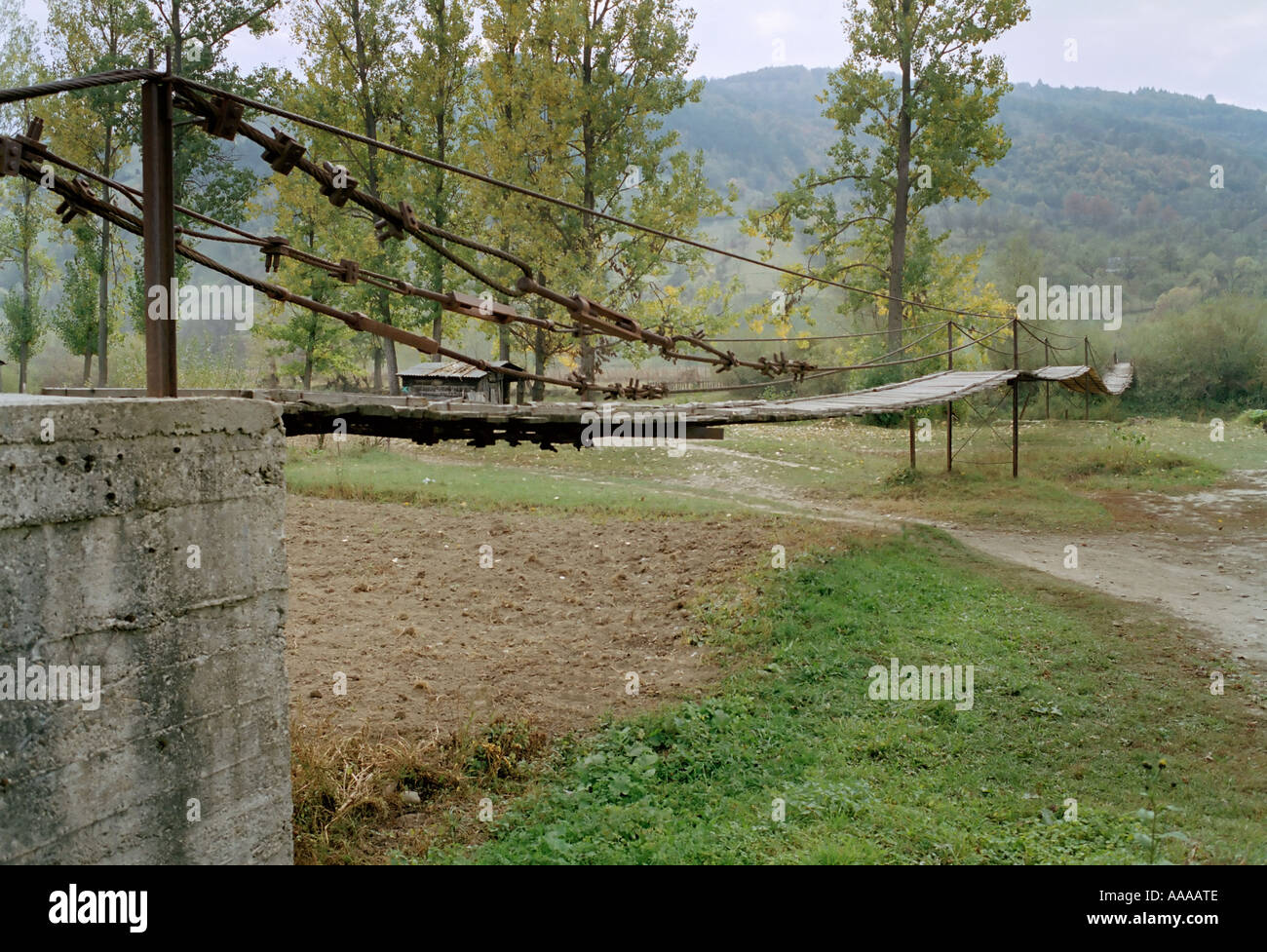 suspension bridge Romania over farmland that often floods Stock Photo ...