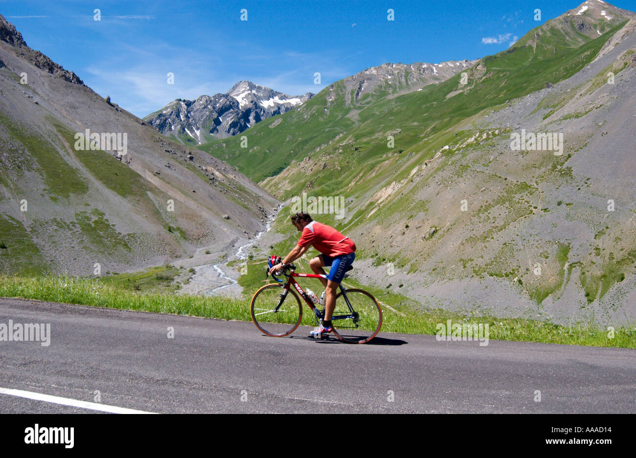Bicyclist on the road D902 between the Col du Telegraphe and the Col du ...