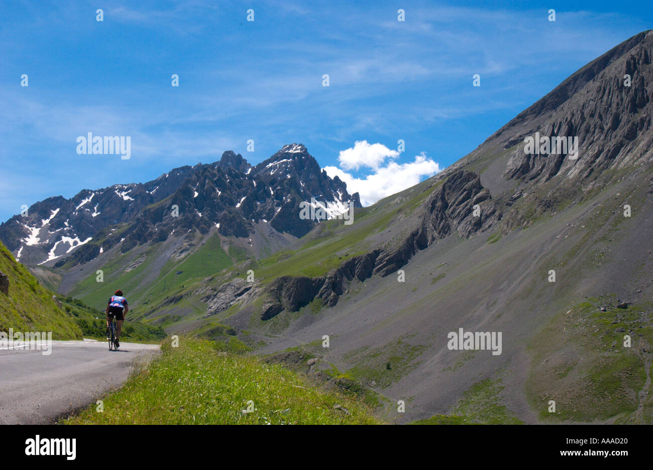 Bicyclist on the road D902 between the Col du Telegraphe and the Col du ...