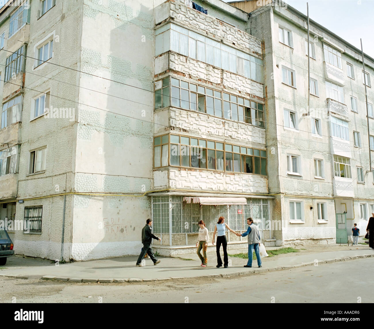 Streetlife in a Romanian town. Friends greeting each other, shaking ...
