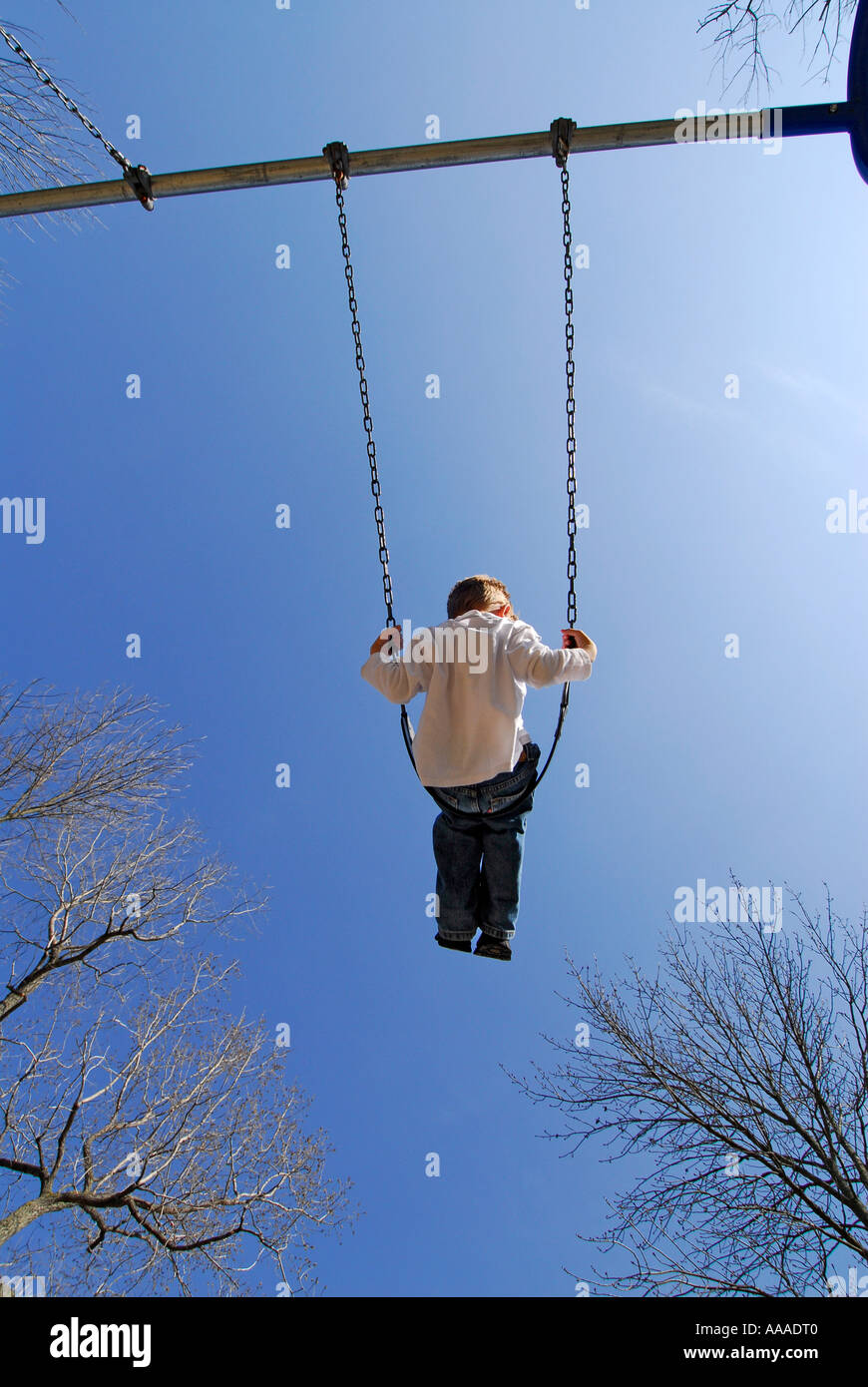 5 year old boy performs daring tricks on a swing Stock Photo - Alamy