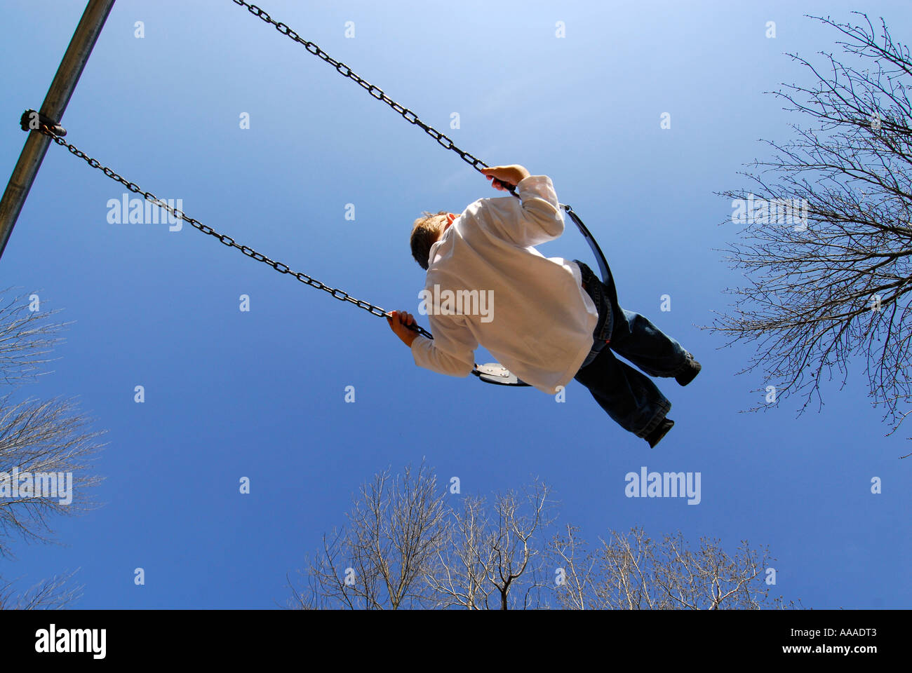 5 year old boy performs daring tricks on a swing Stock Photo - Alamy