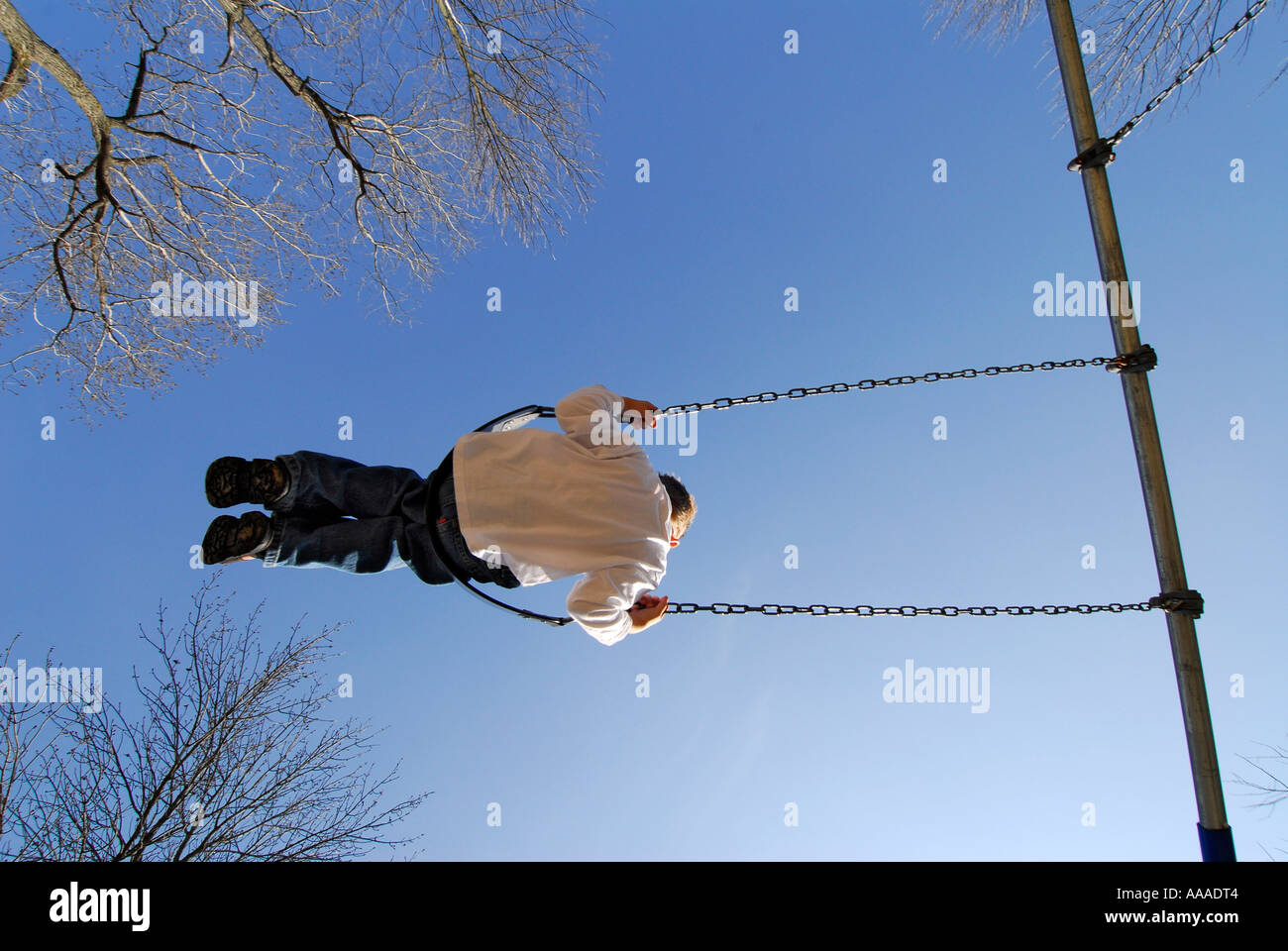 5 year old boy performs daring tricks on a swing Stock Photo - Alamy