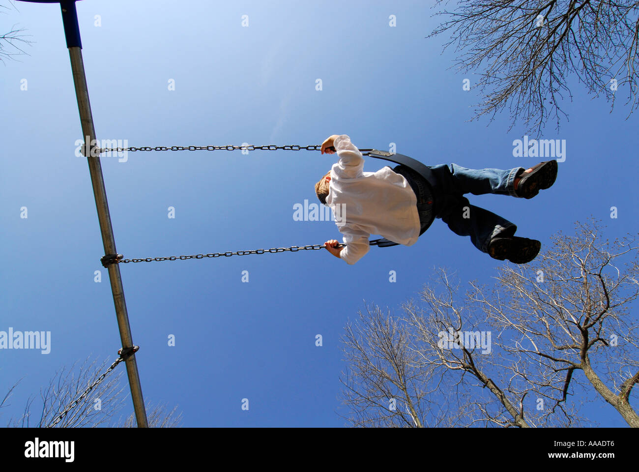 5 year old boy performs daring tricks on a swing Stock Photo - Alamy