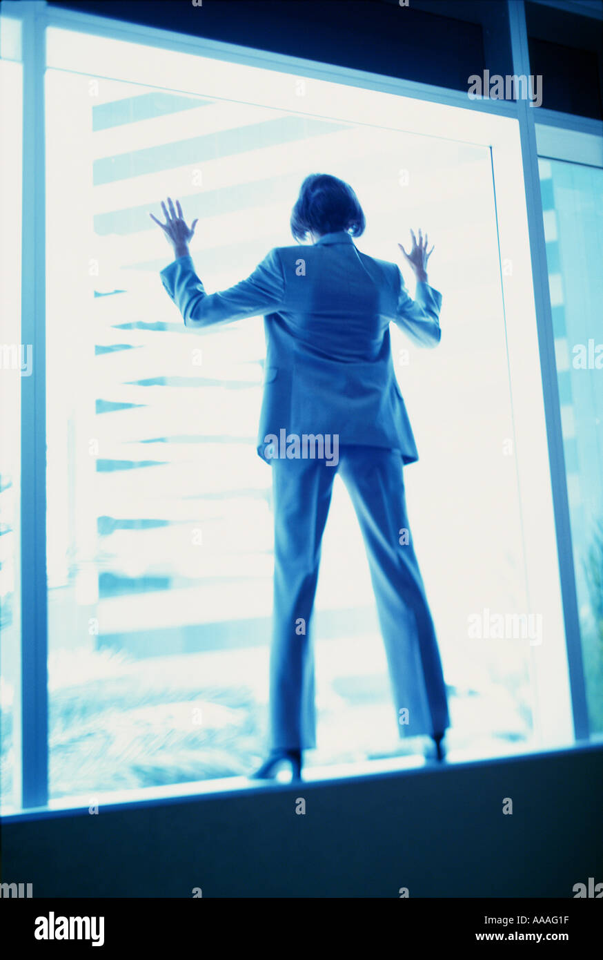 Woman standing window rear view hi-res stock photography and images - Alamy