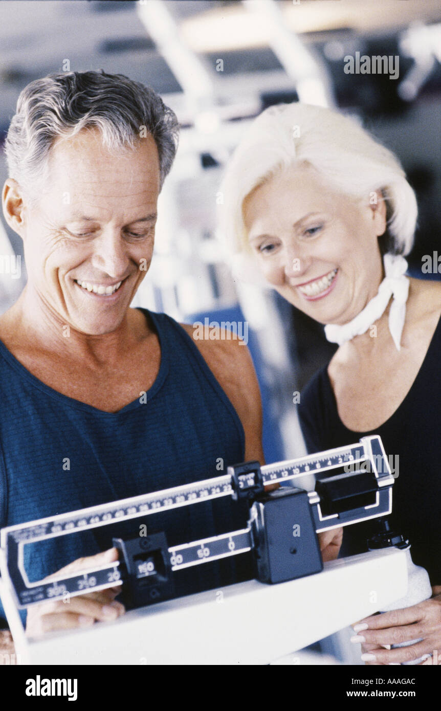 Man standing on a weighing scale Stock Photo - Alamy