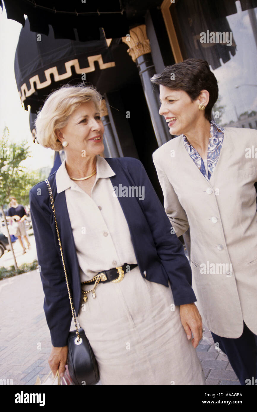 Two women walking Stock Photo - Alamy