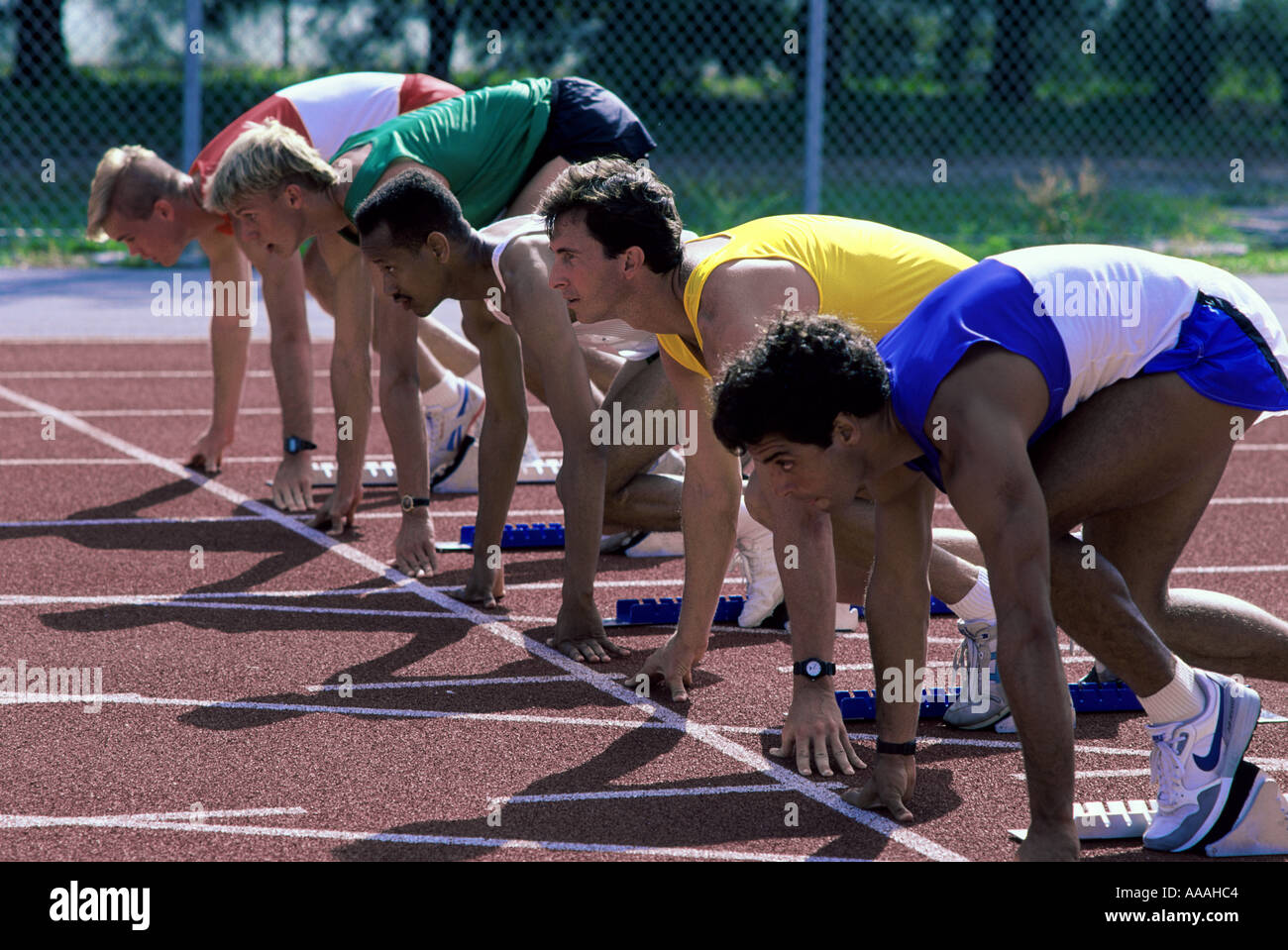 Side profile of male runners at the starting line Stock Photo - Alamy
