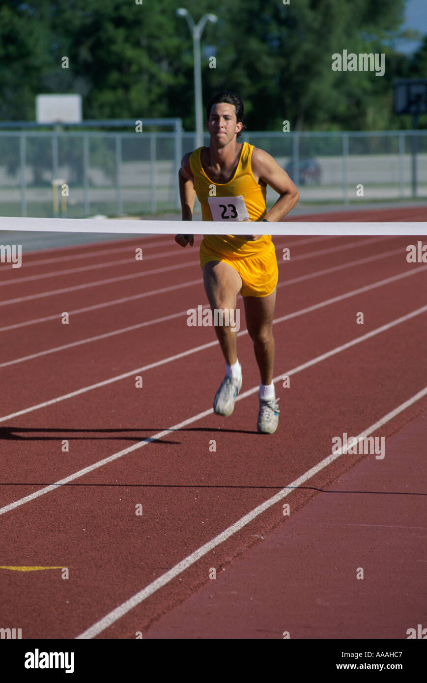 Male runner crossing a finishing line Stock Photo - Alamy