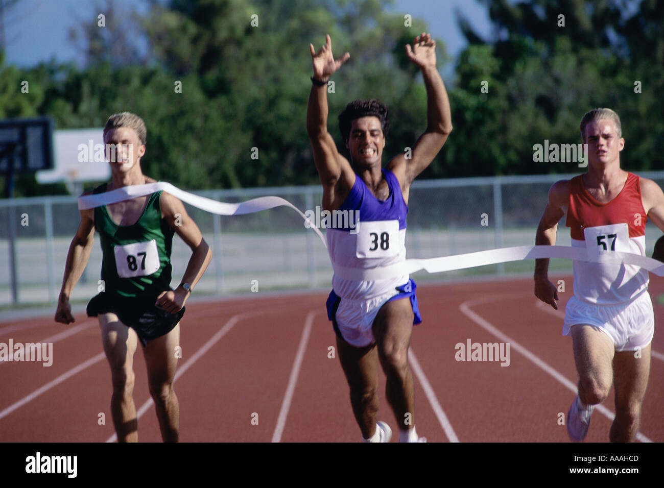 Three male runners crossing finish line hi-res stock photography and images - Alamy