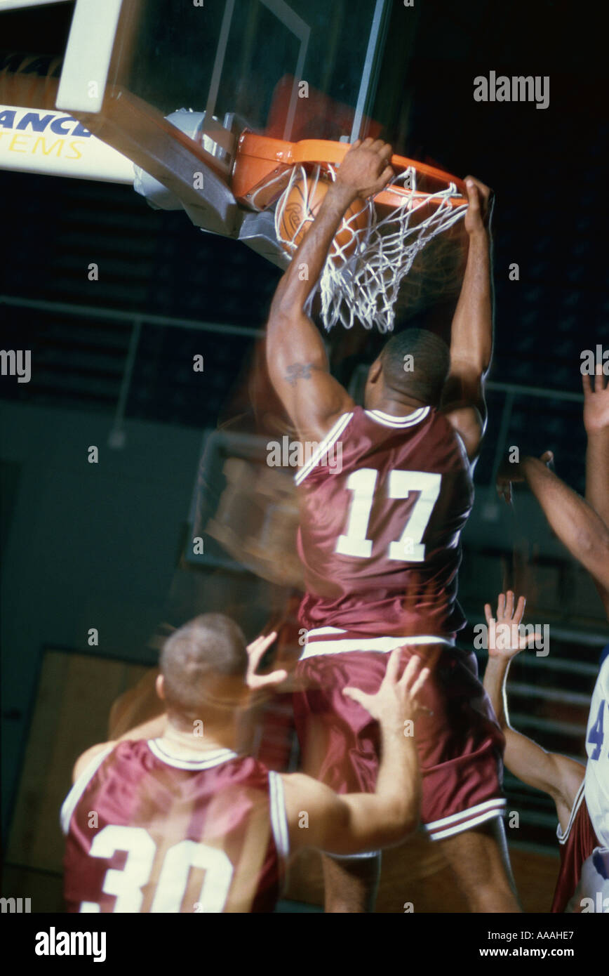 Rear view of a basketball player slam dunking Stock Photo - Alamy