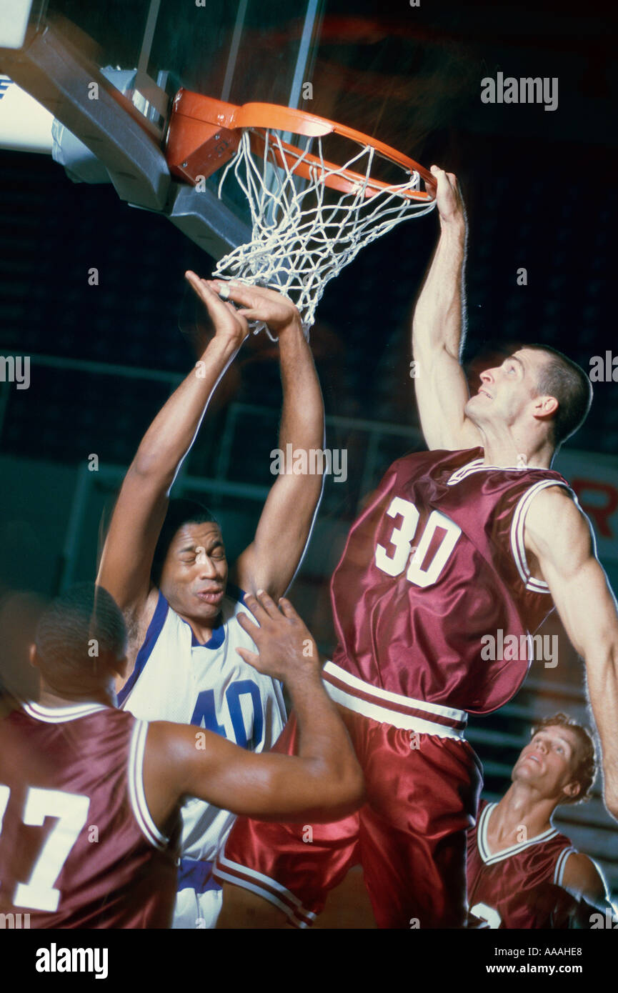 Basketball player slam dunking a basketball Stock Photo - Alamy