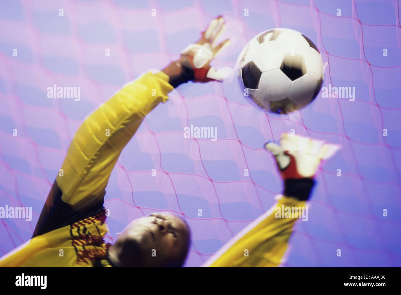 Low angle view of a goalie catching a ball Stock Photo - Alamy