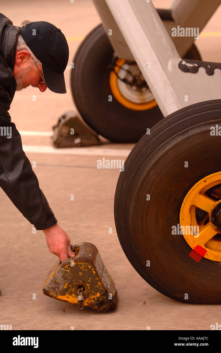 A PILOT REMOVES THE CHOCKS FROM A SWORDFISH PLANE AT RNAS YEOVILTON ...