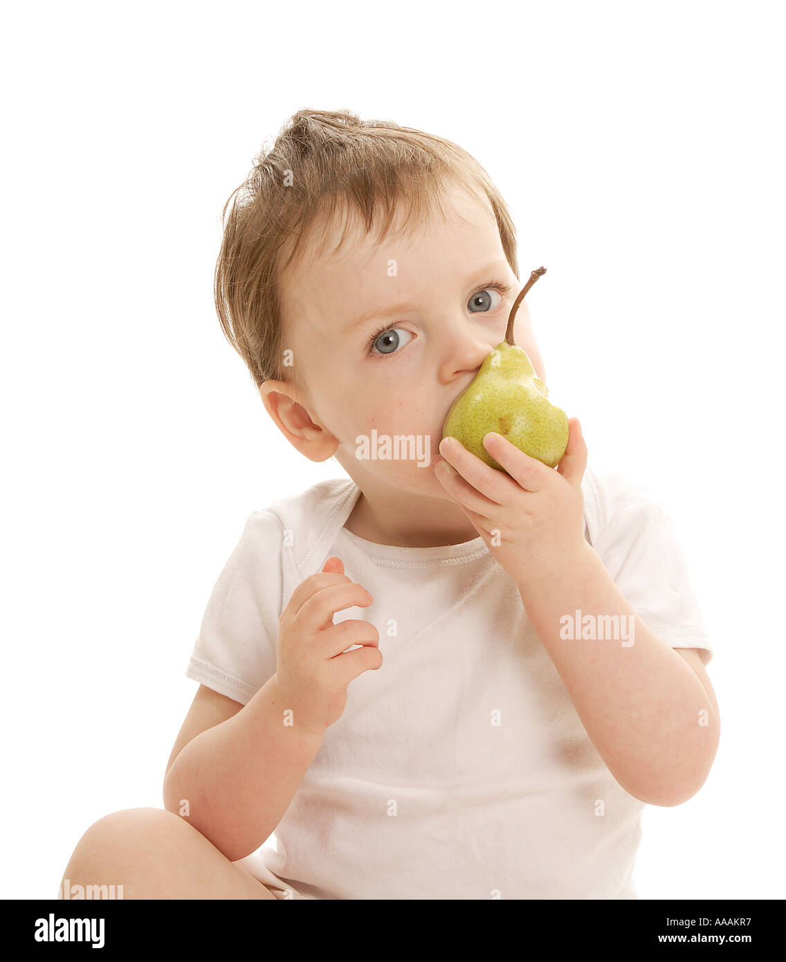 Toddler eating pear Stock Photo - Alamy