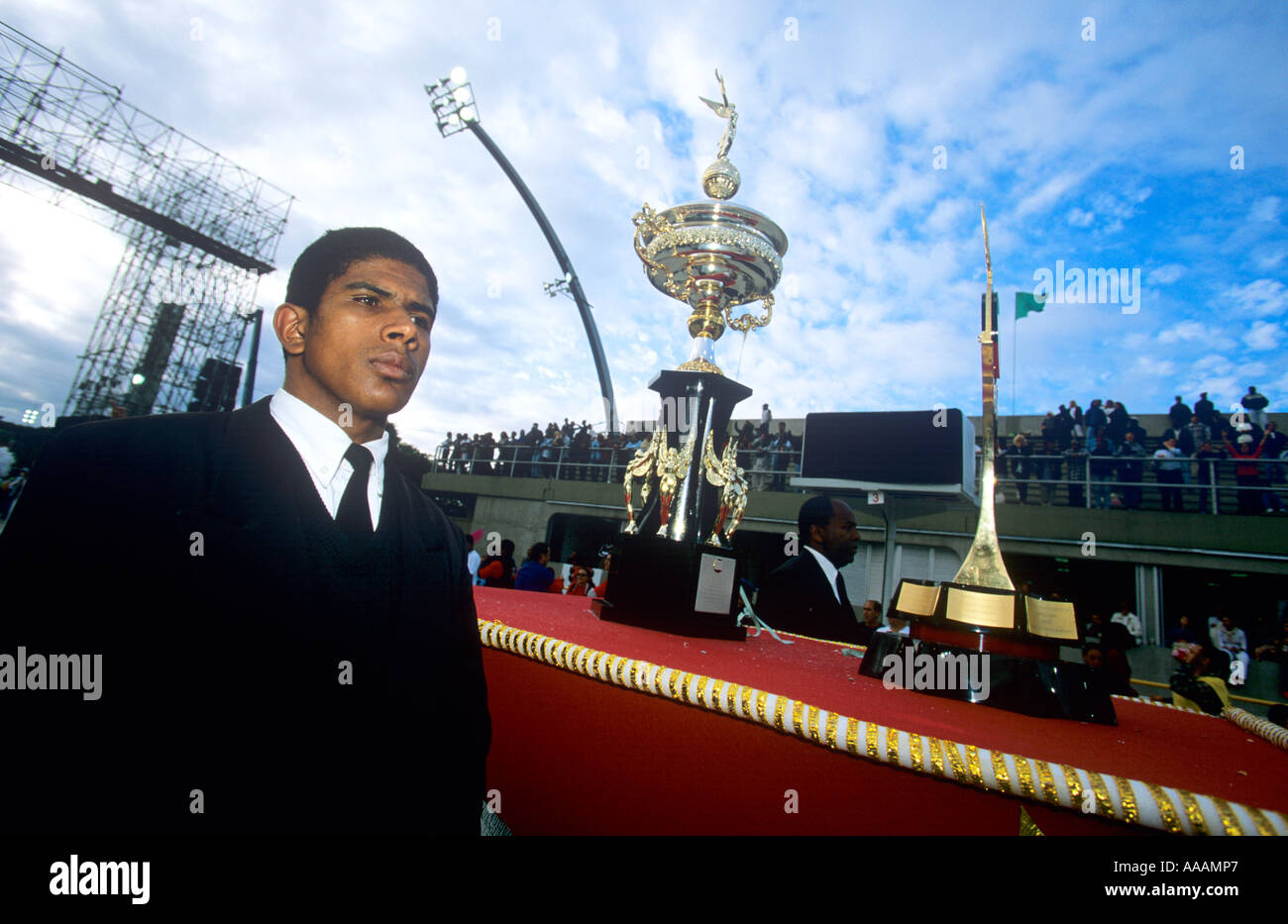 Security guard protecting the trophies for the best carnival school at ...