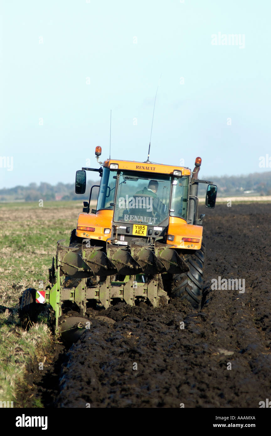 Tractor ploughing field after harvest Stock Photo - Alamy