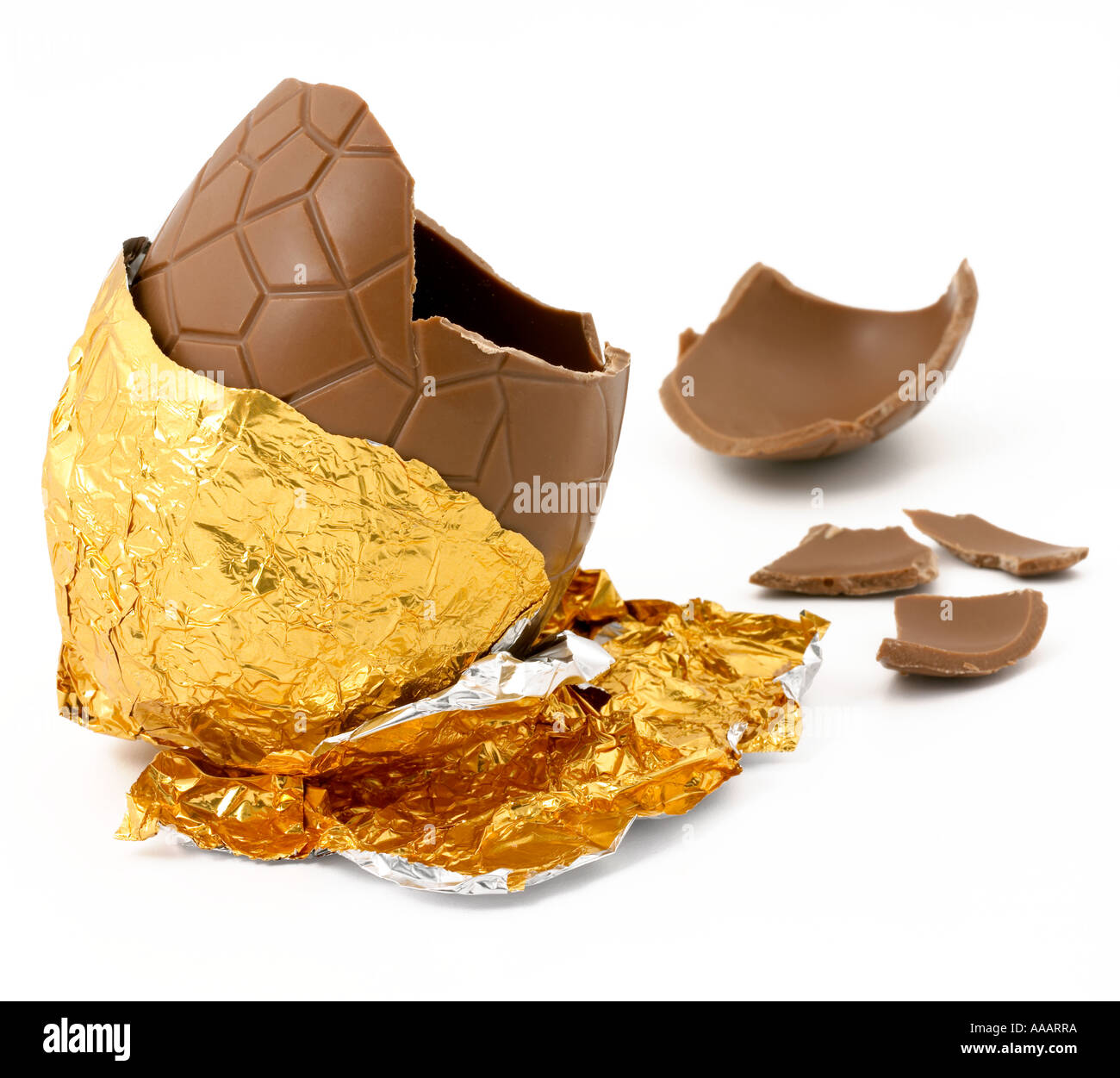Cracked easter egg with foil cut out on a white background Stock Photo ...