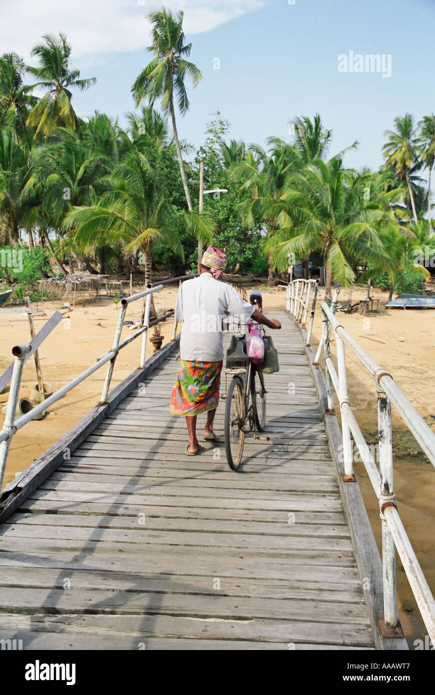 Man Walking Across Wooden Bridge Pushing Bicycle Stock Photo - Alamy