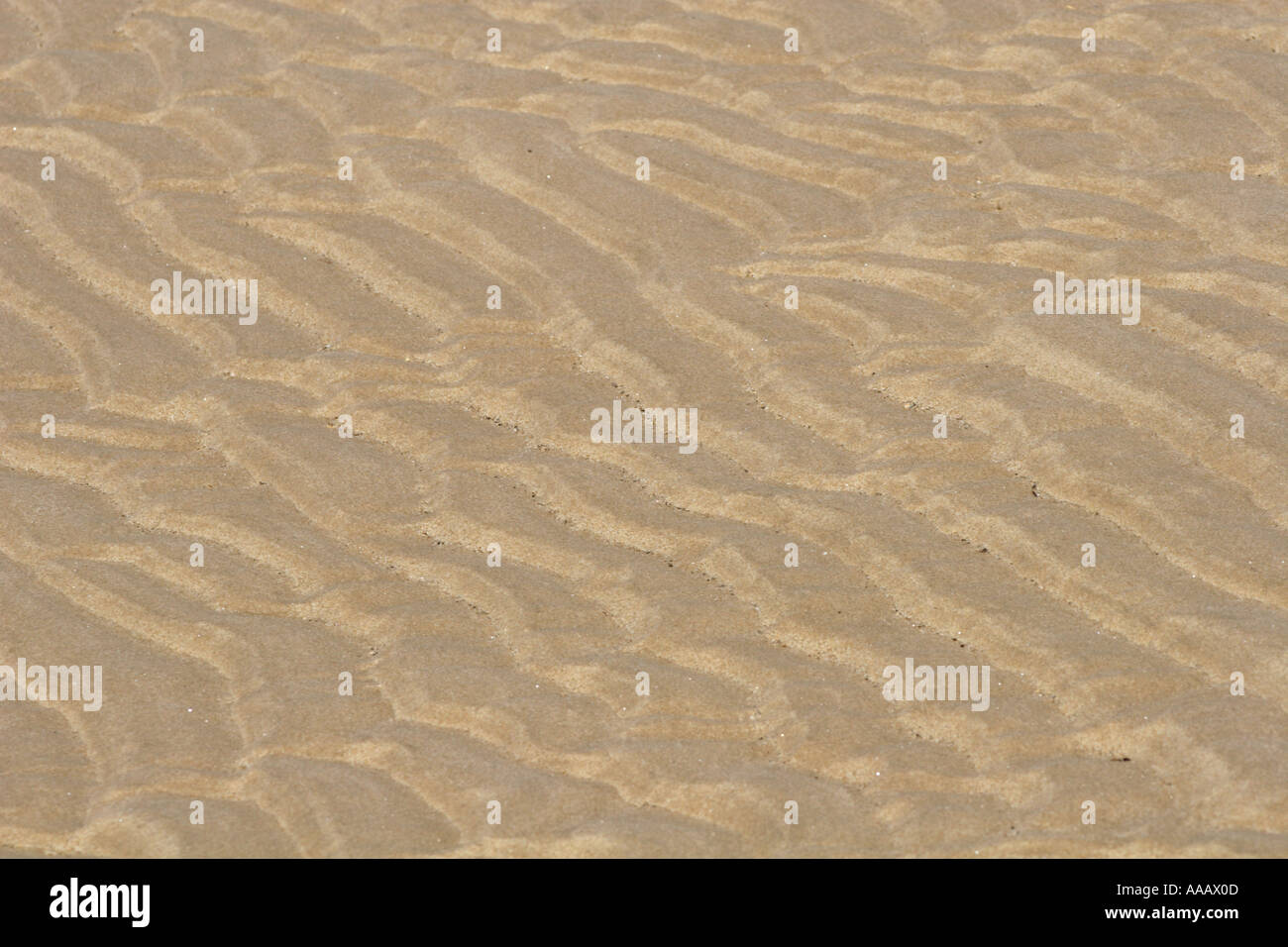 Patterns in sand on beach UK Stock Photo - Alamy