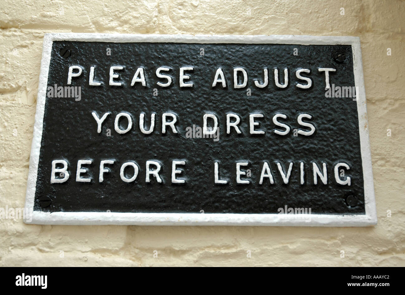 Please adjust your dress before leaving sign Stock Photo - Alamy
