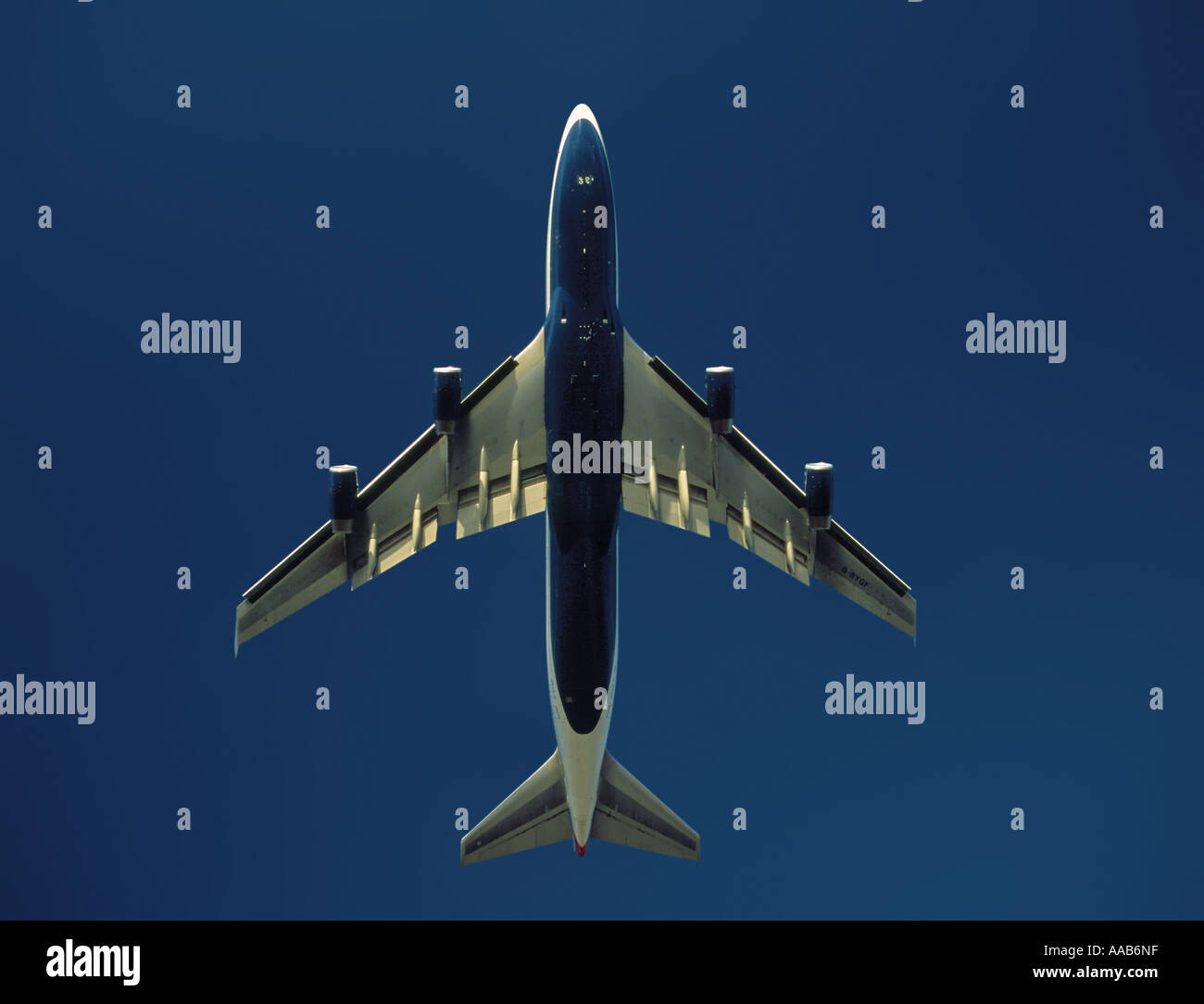 British Airways Boeing 747 seen from straight below against a deep blue ...