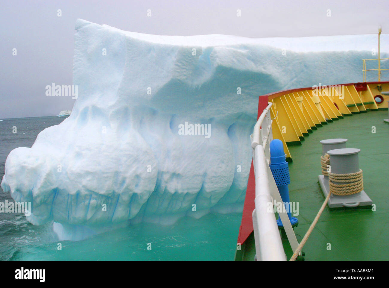 Icebreaker passes huge Antarctic iceberg at close quarters Stock Photo ...