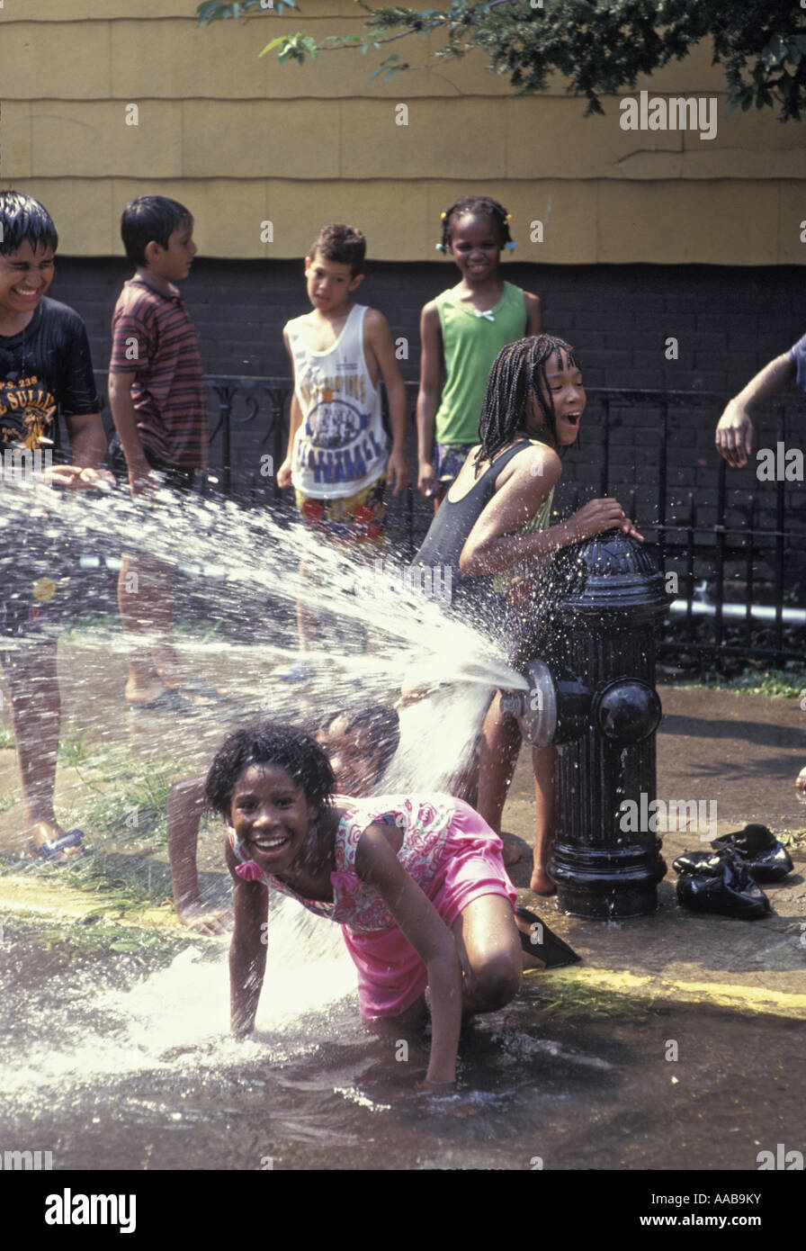 Children getting relief from the summer heat by way of a fire hydrant ...