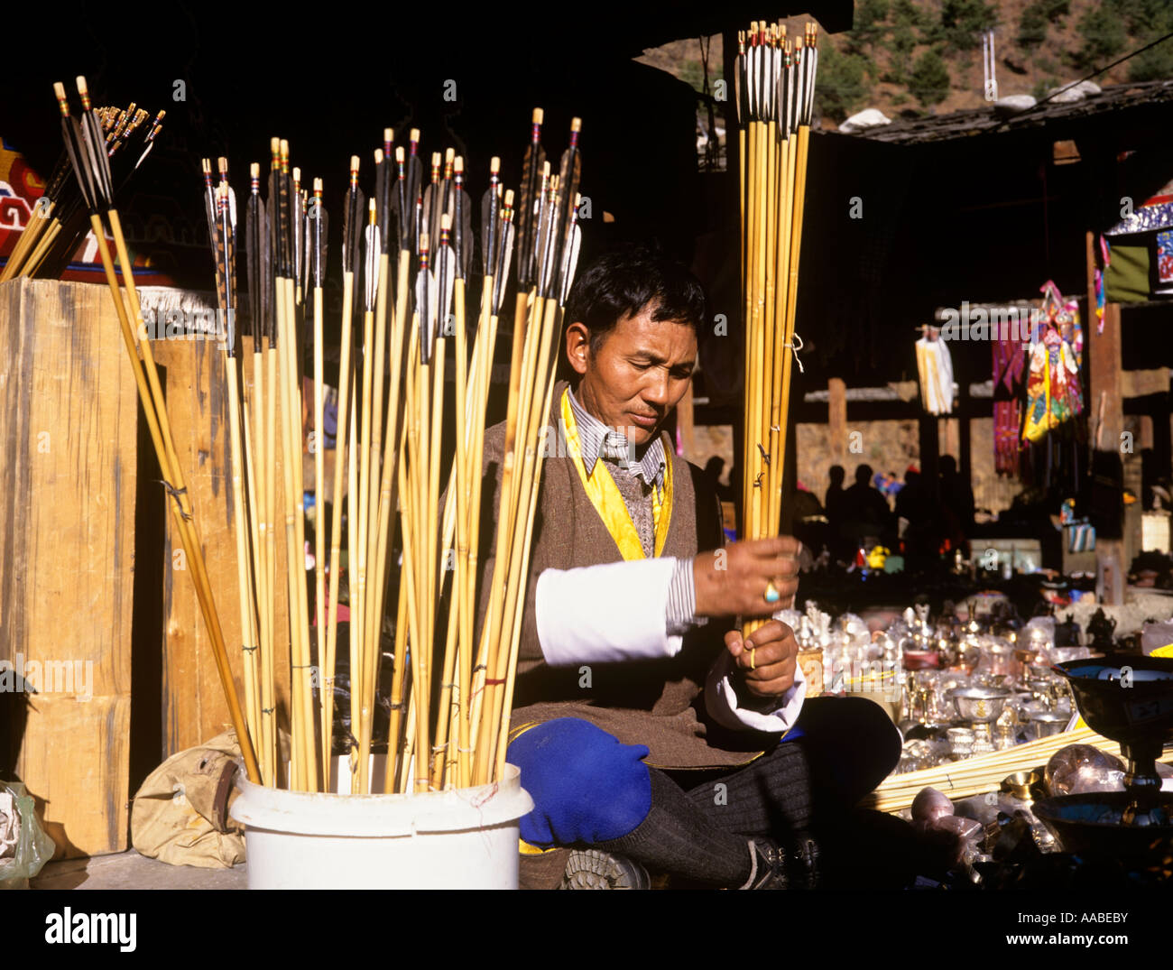 Bhutan Thimpu weekend market man at stall selling traditional archery ...