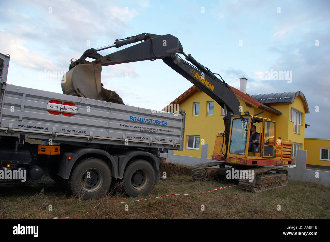 excavator loading earth onto lorry Stock Photo - Alamy