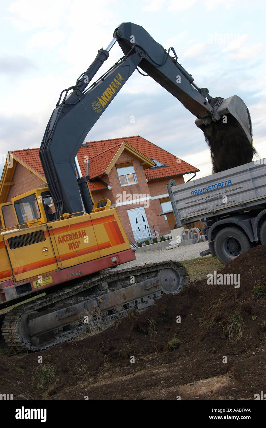 excavator loading earth onto lorry Stock Photo - Alamy