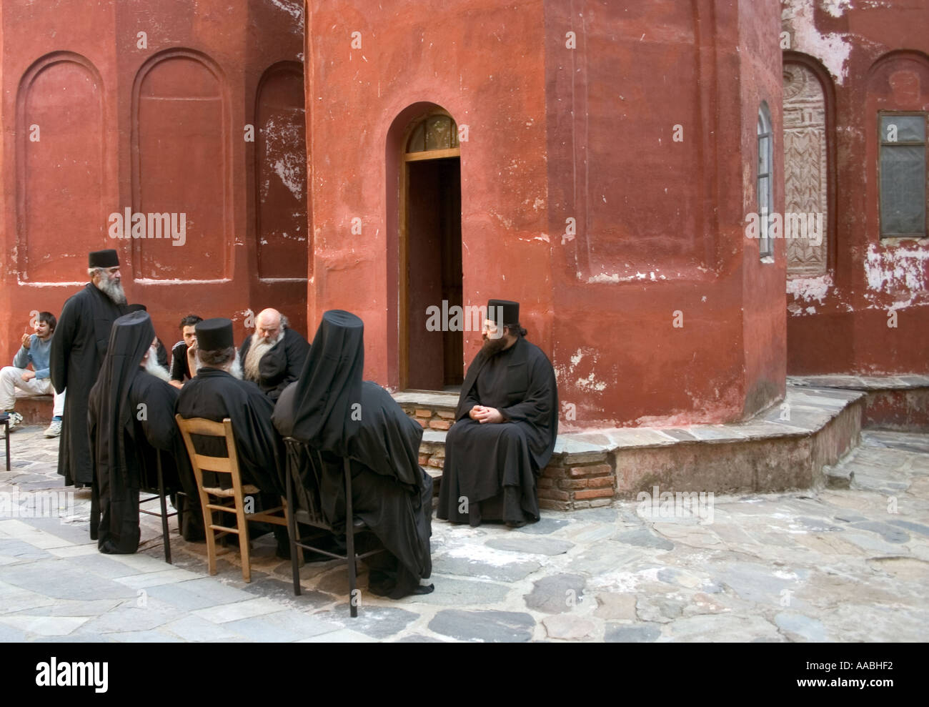 monks sitting in the courtyard Stock Photo - Alamy