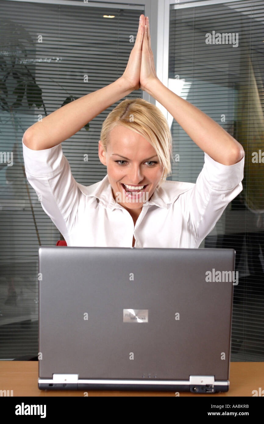 Woman with computer, jubilant Stock Photo - Alamy