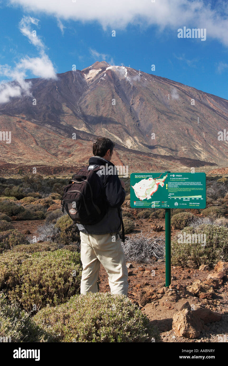Male hiker reading footpath sign near mount Teide on Tenerife in the ...